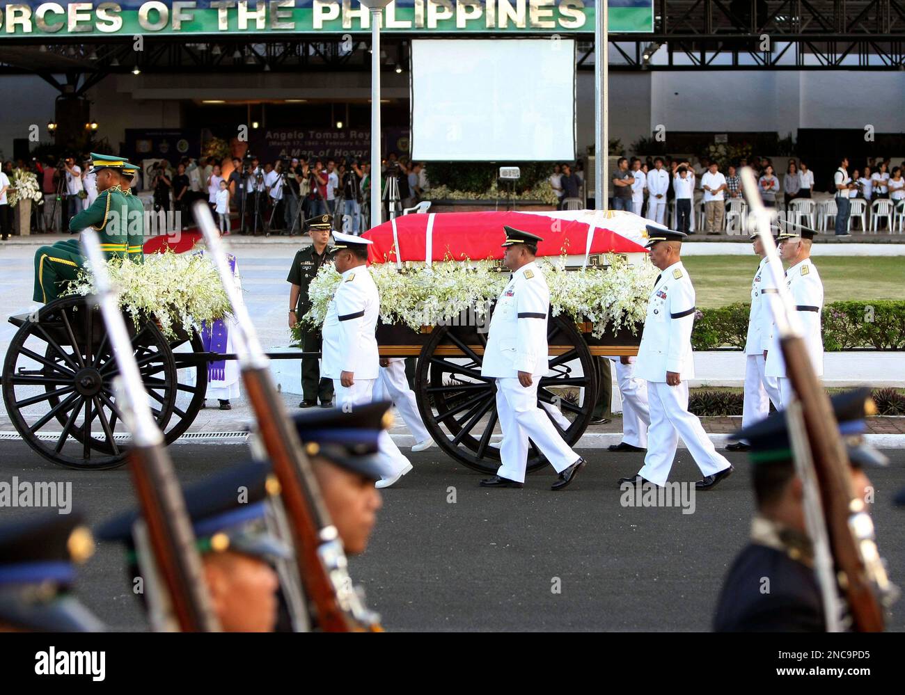Philippine military generals escort the caisson carrying the flag ...