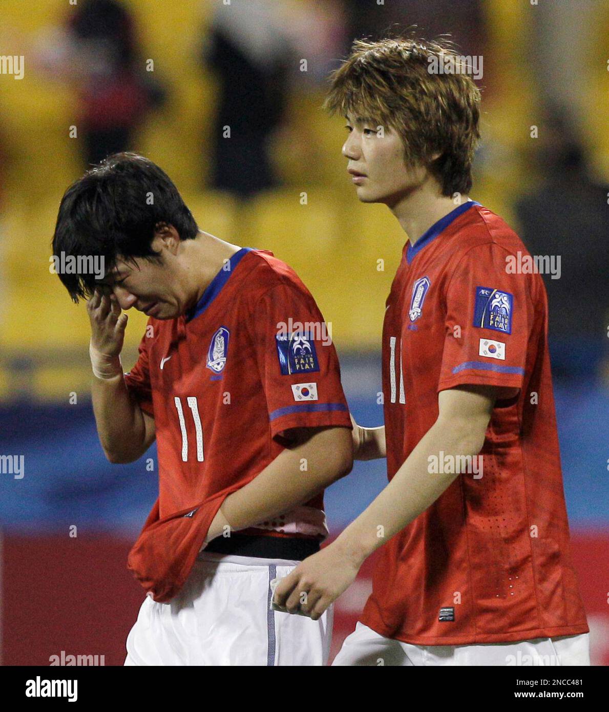 South Korea's player Son Heung Min, left, cries after lost the AFC ...
