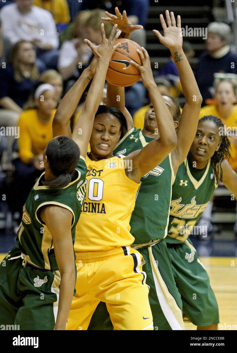 West Virginia's Asya Bussie, center, is surrounded by South Florida ...