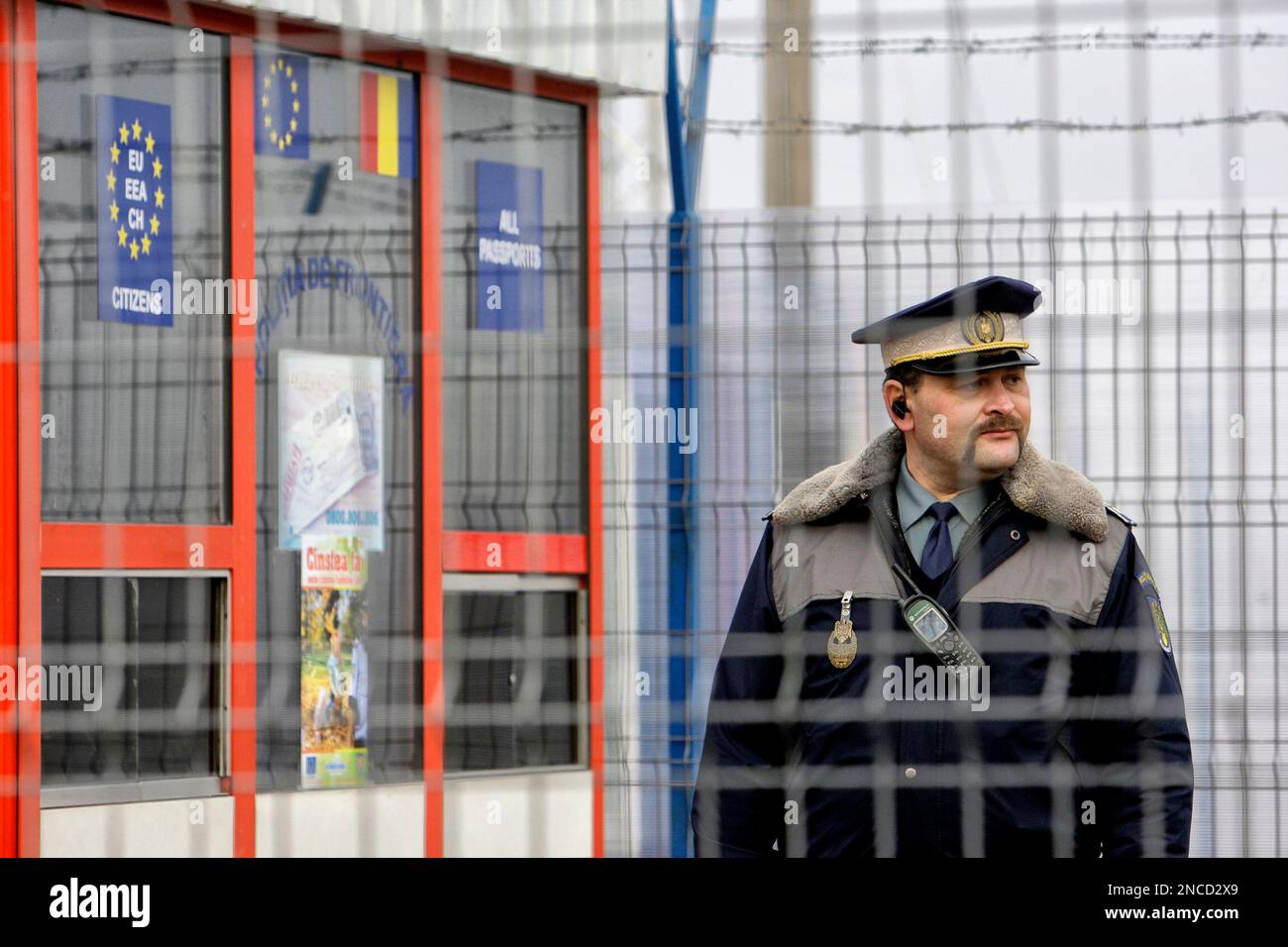 A Romanian border police officer stands guard at the railway border ...