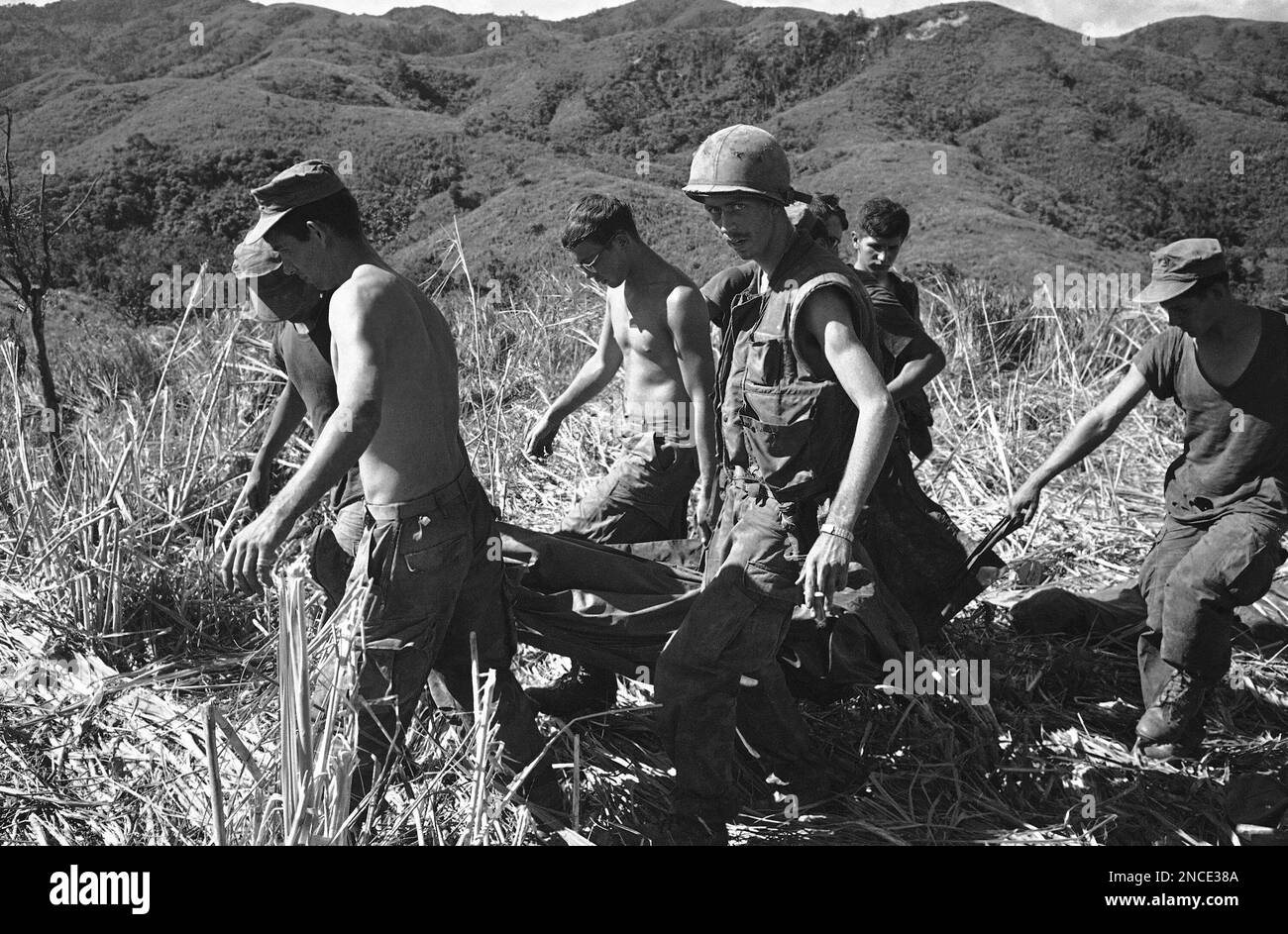 U.S. Marines of the 3rd Battalion, 9th Marines, carry one of their dead to an evacuation ...