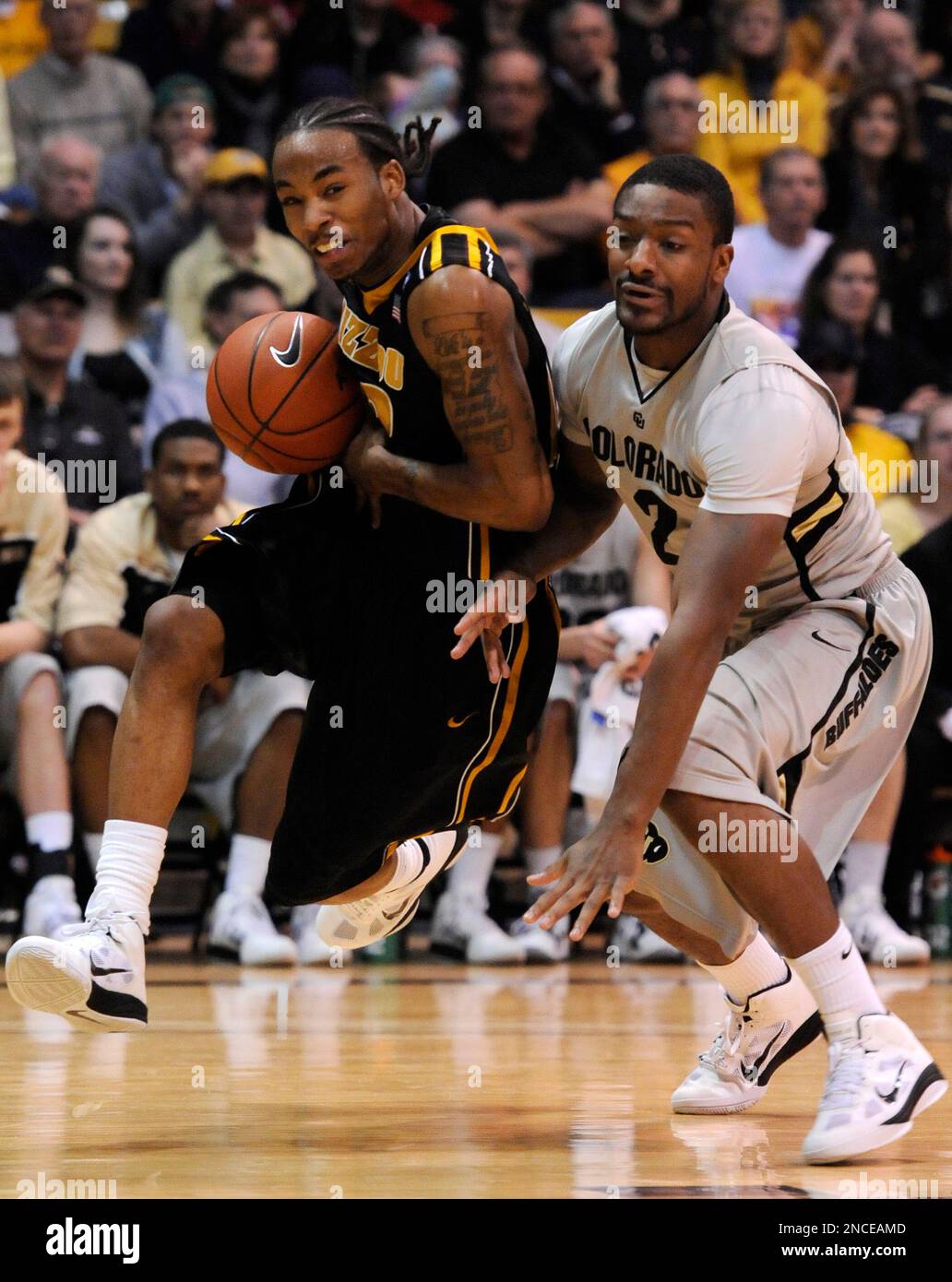 Missouri guard Marcus Denmon (12) drives past Colorado guard Shannon ...