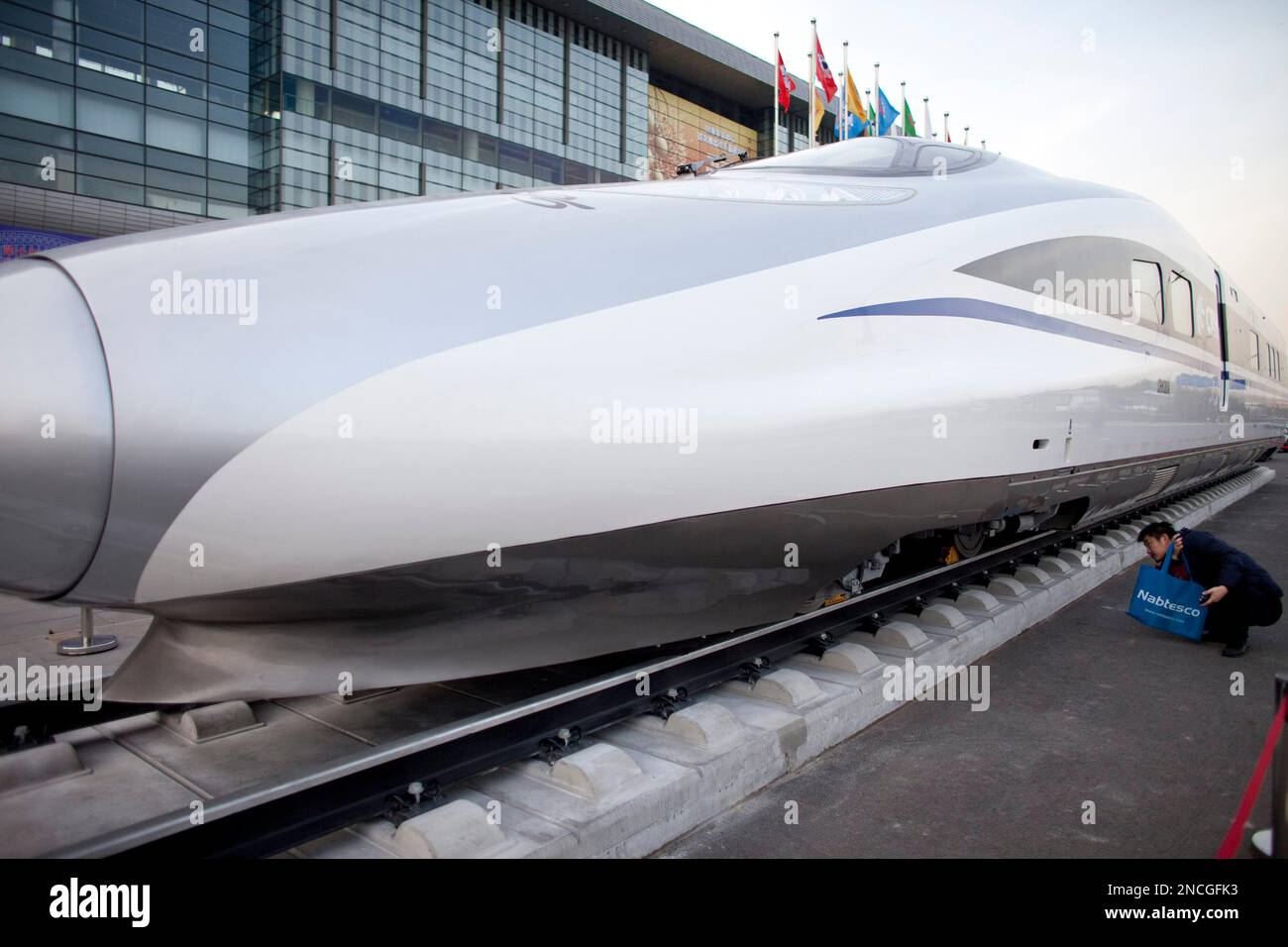 In this Dec. 7, 2010 photo, a man checks a CRH380A high-speed Chinese passenger train, the model ...