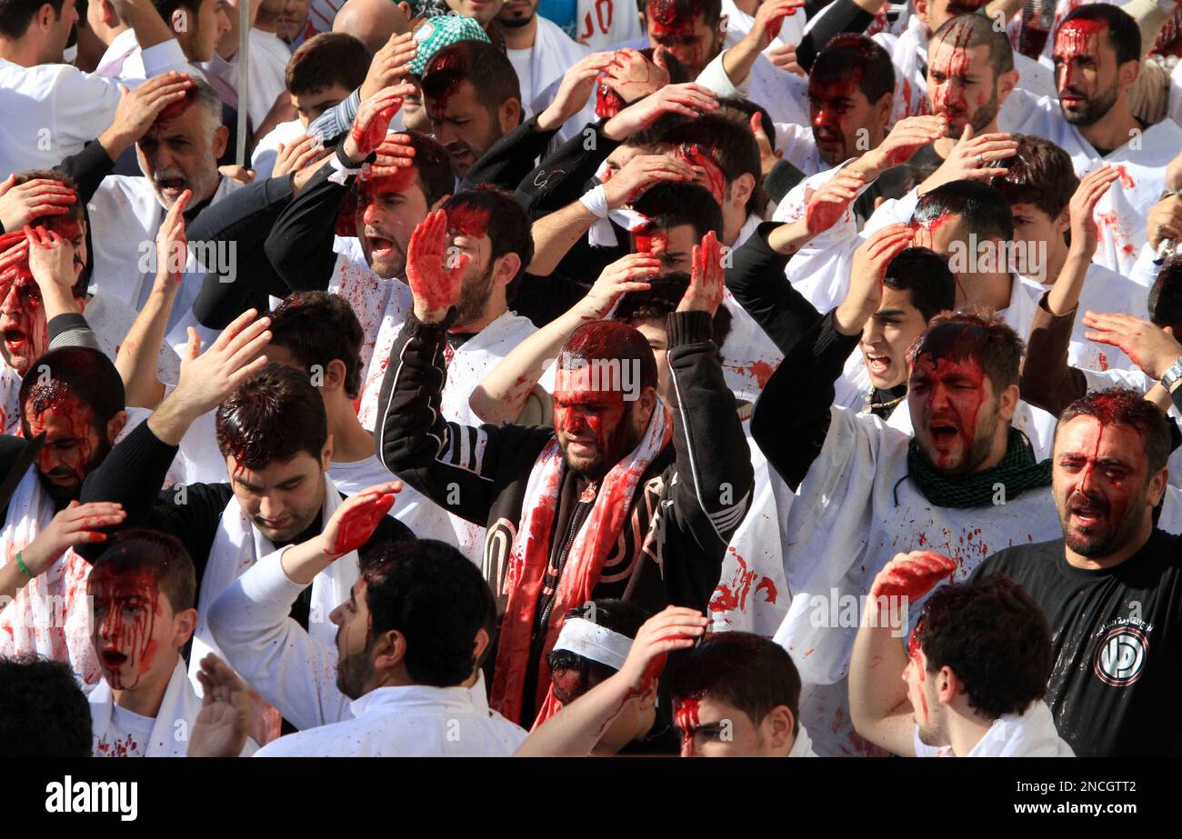 Lebanese Shiite men react as they bleed from the head from self ...