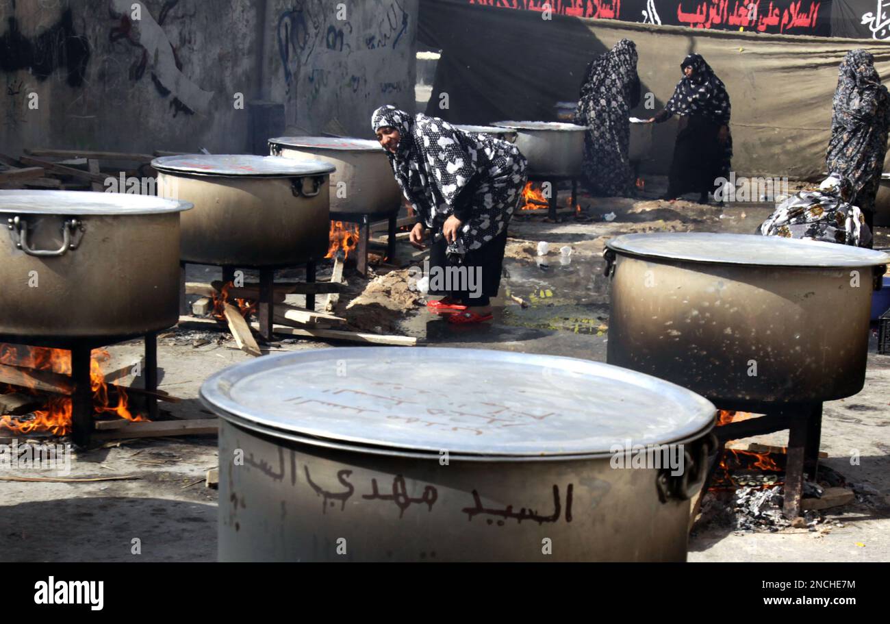 Bahraini women prepare steaming pots of stews and rice Sunday, Dec. 12 ...