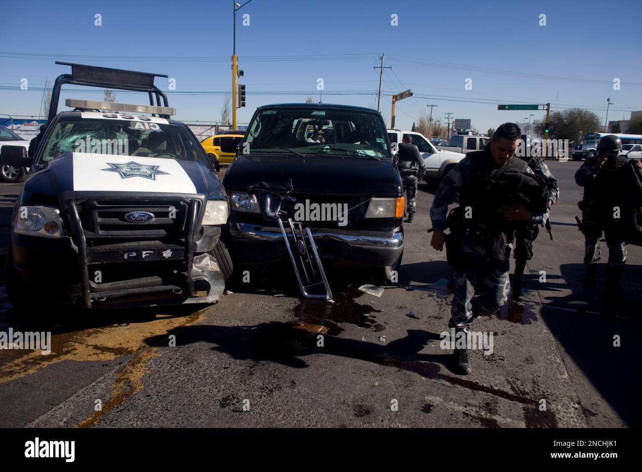 State police officers walk next to a Mexican federal police vehicle and ...