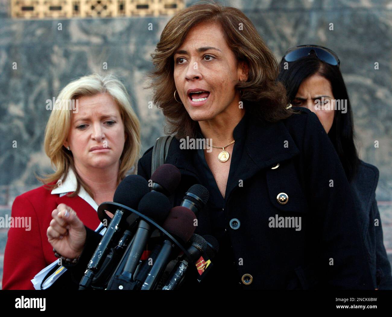 Sister-in-law Jeane Burgos, center, addresses the media after a federal ...