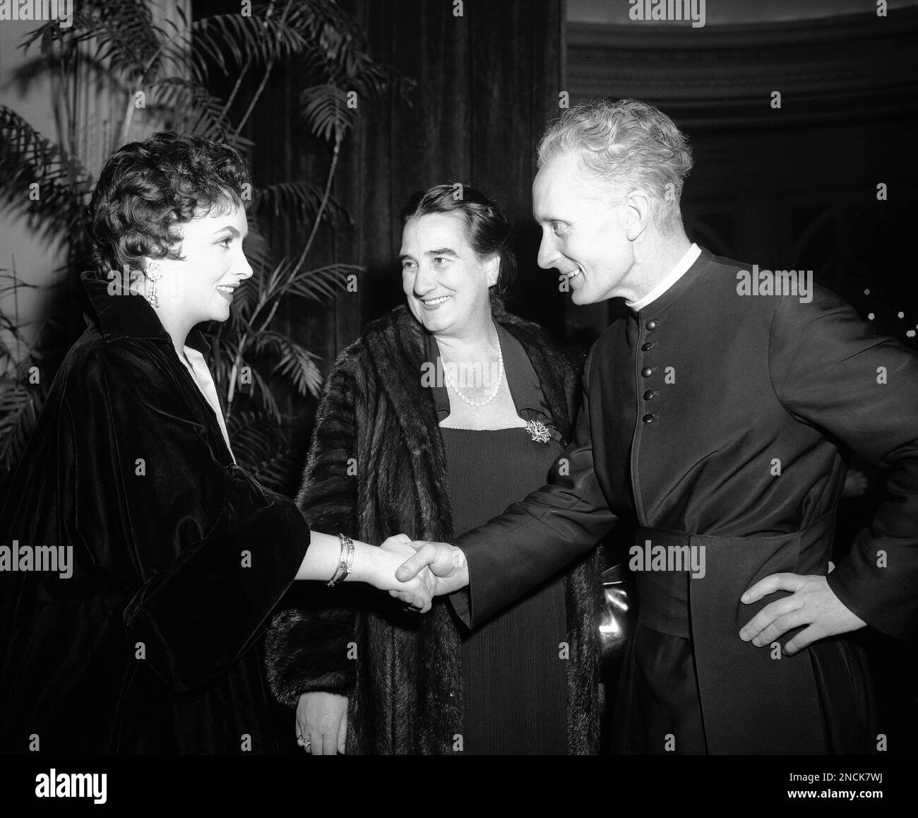 Gina Lollobrigida, left, Italian screen star, shakes hands with Don ...
