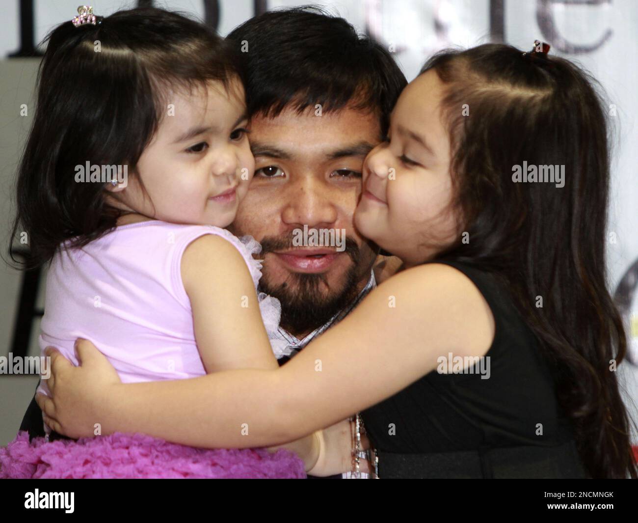 Filipino boxing champion Manny Pacquiao hugs his daughters Queen ...