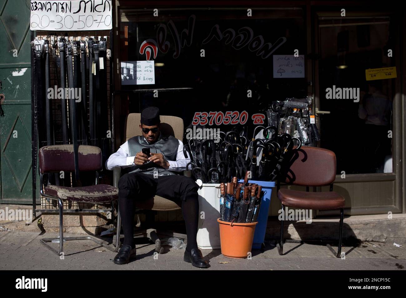 U.S. rapper Jamal "Shyne" Barrow sits in front of a barber shop as he ...