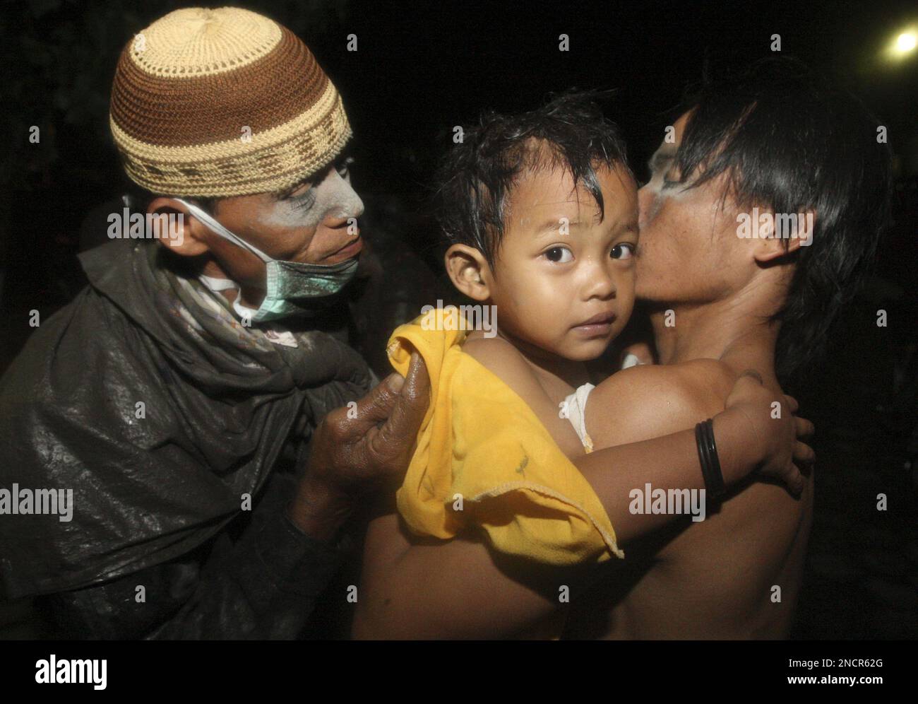 A man kiss his boy after flee their home following another eruption ...