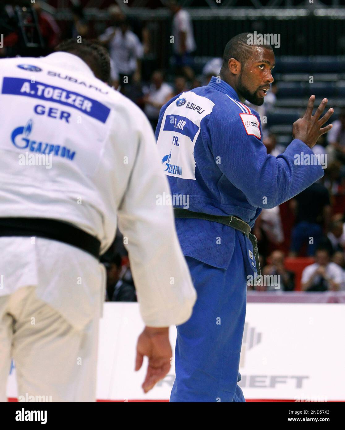 Teddy Riner, right, of France reacts after he won the men's over 100 Kg ...