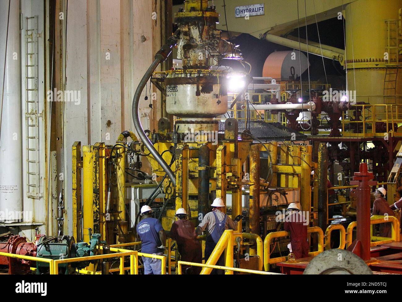 Workers watch as the Deepwater Horizon blowout preventer stack is ...