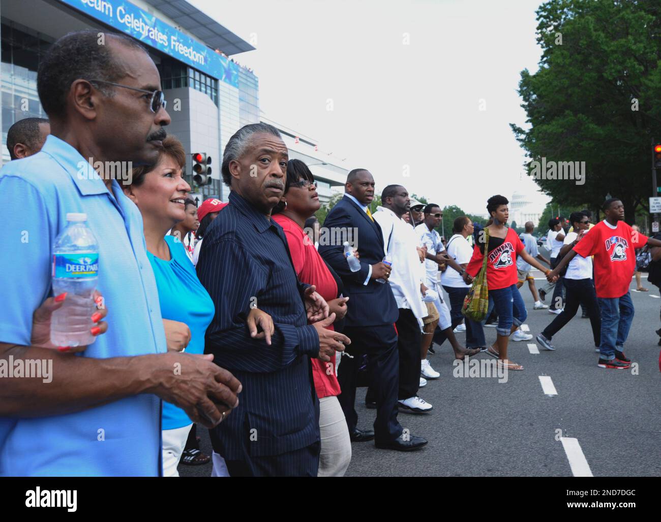 Rev. Al Sharpton, third from left, and others march through Washington ...