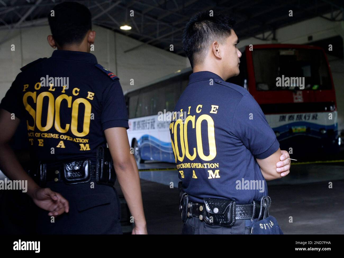 Local Police investigators observe other Filipino investigators, not in ...