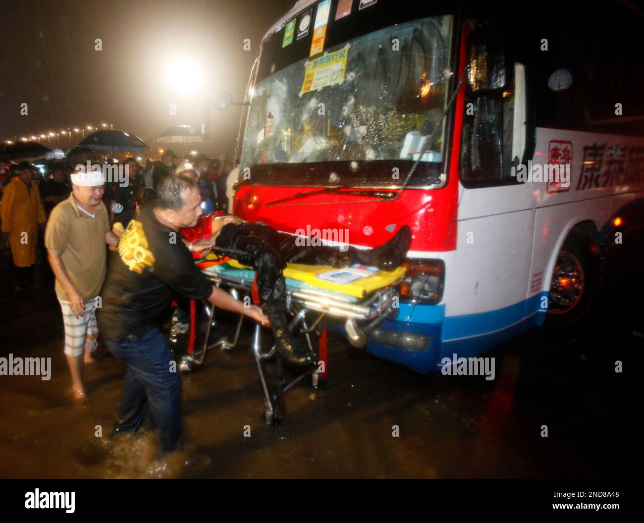 Rescue units wheel away the body of hostage-taker Rolando Mendoza, 55 ...