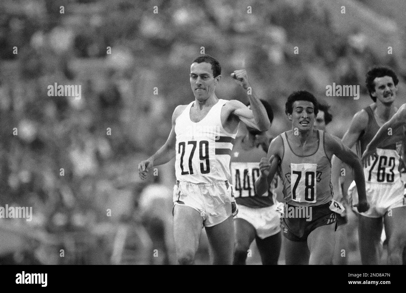 Steve Ovett of Britain, left, bites his lip as he crosses finish line ...