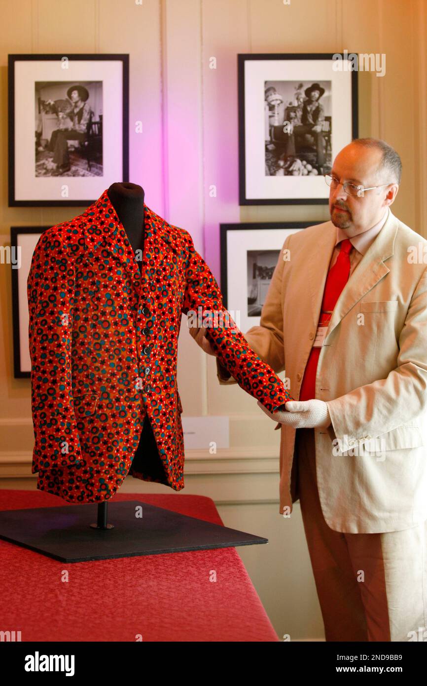 Deputy Director of the museum, Martin Wyatt poses with a Jimi Hendrix's ...