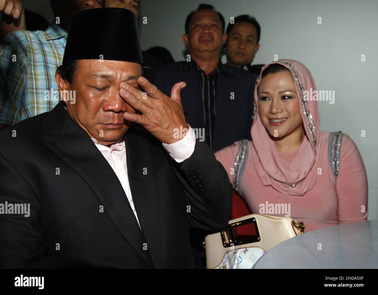 Malaysian lawmaker Bung Mokhtar Radin, left, wipes tears from his eyes ...