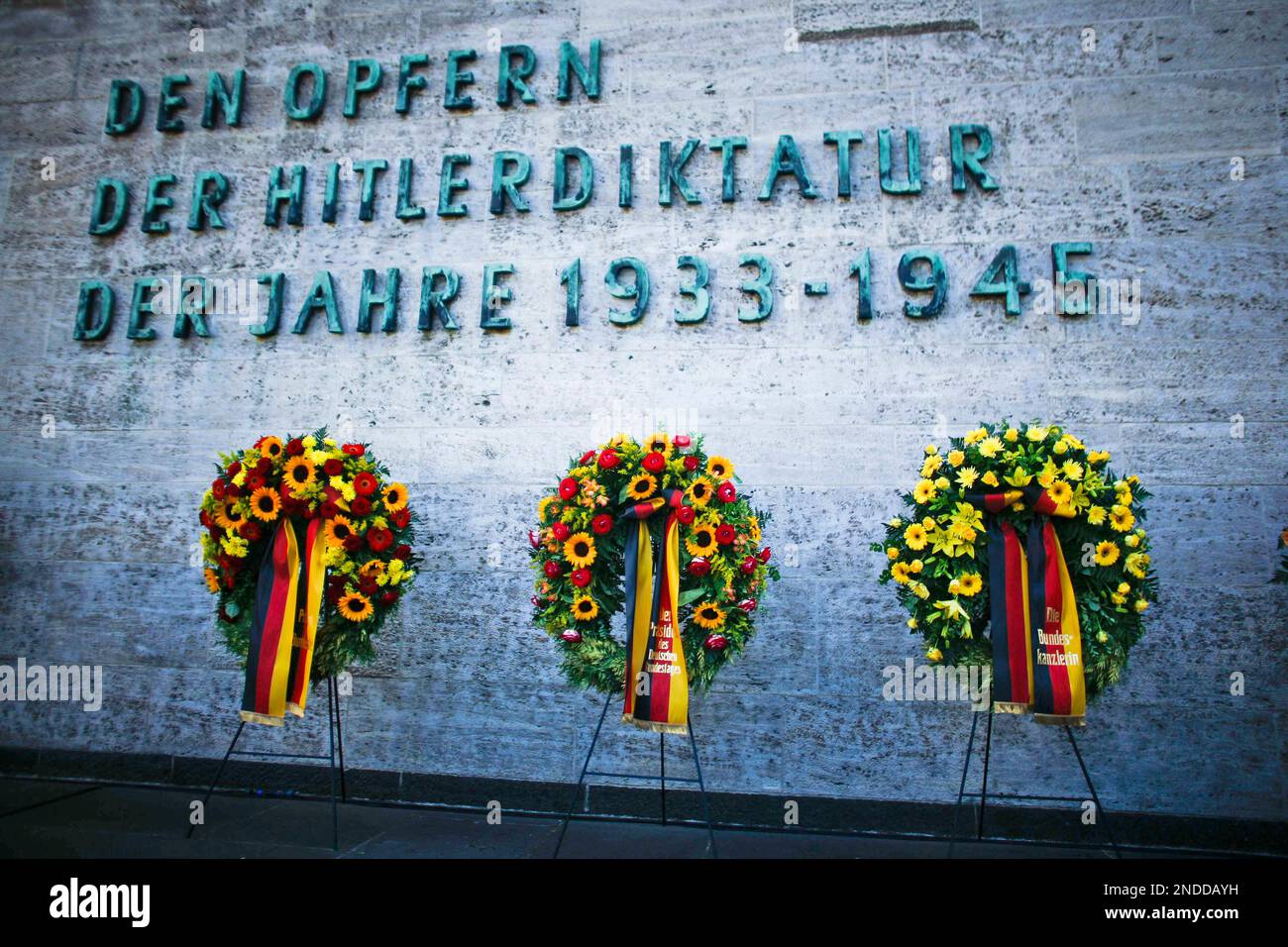 Wreaths placed under the letters reading 'For the victims of the Hitler ...