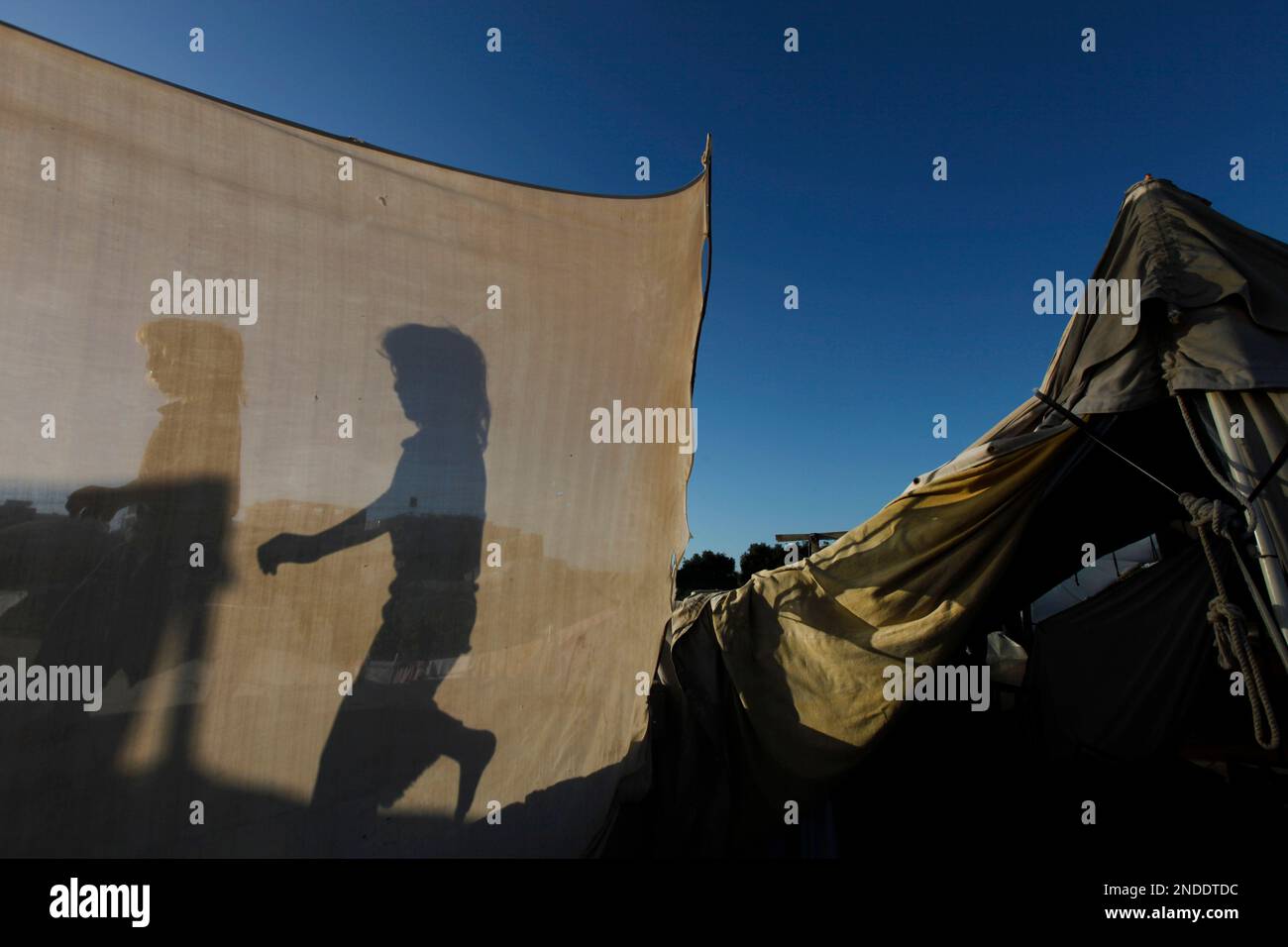 Palestinian Dia Awaja, 4, plays on the makeshift structures that house ...