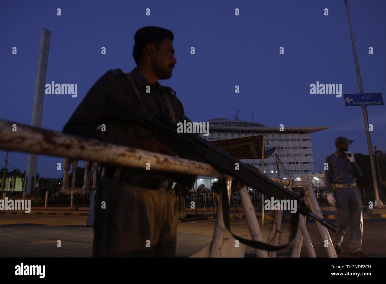 A Pakistani police officer stands at a security check post in Lahore ...