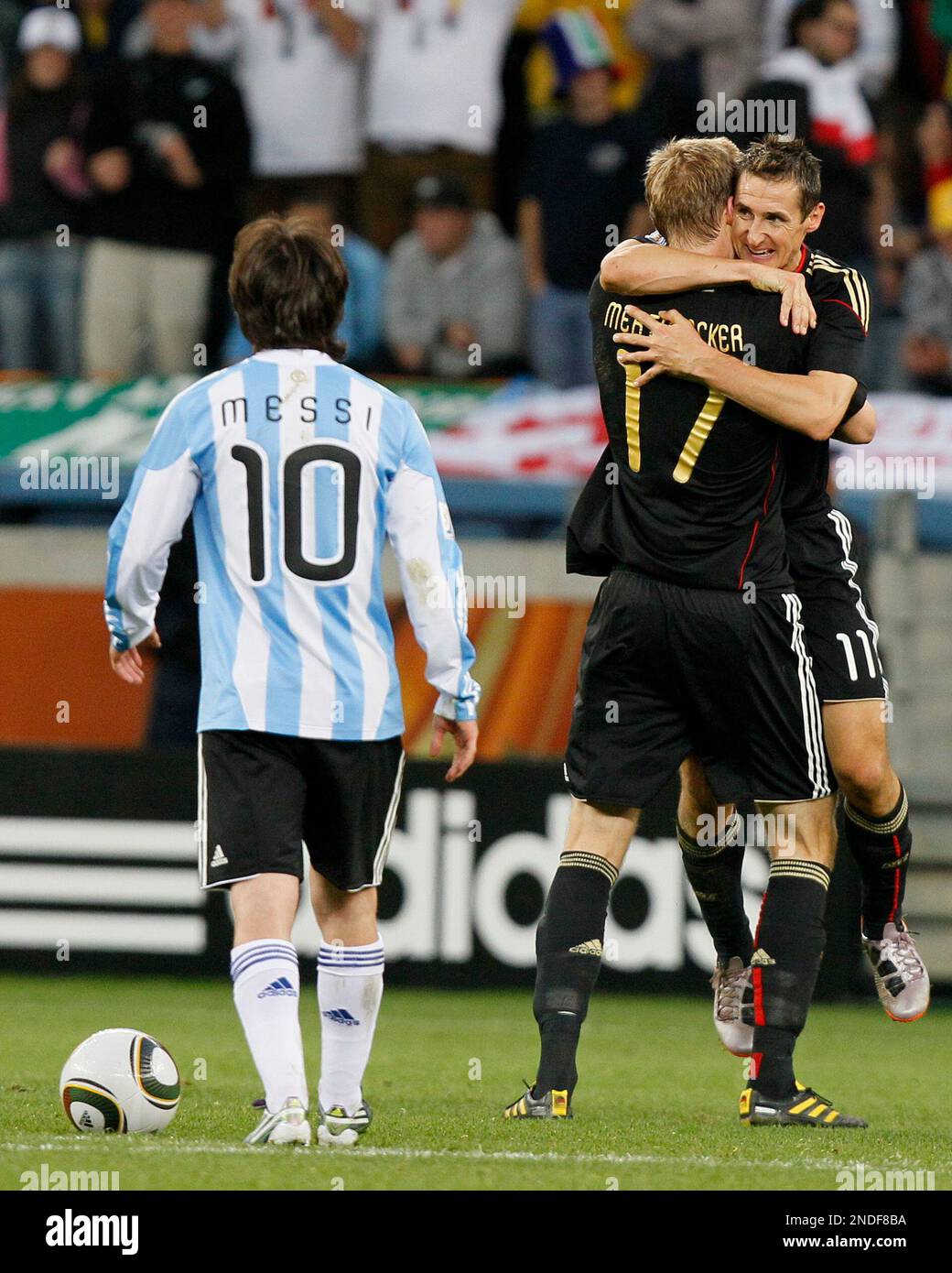 Argentina's Lionel Messi, left, walks past Germany's Miroslav Klose ...