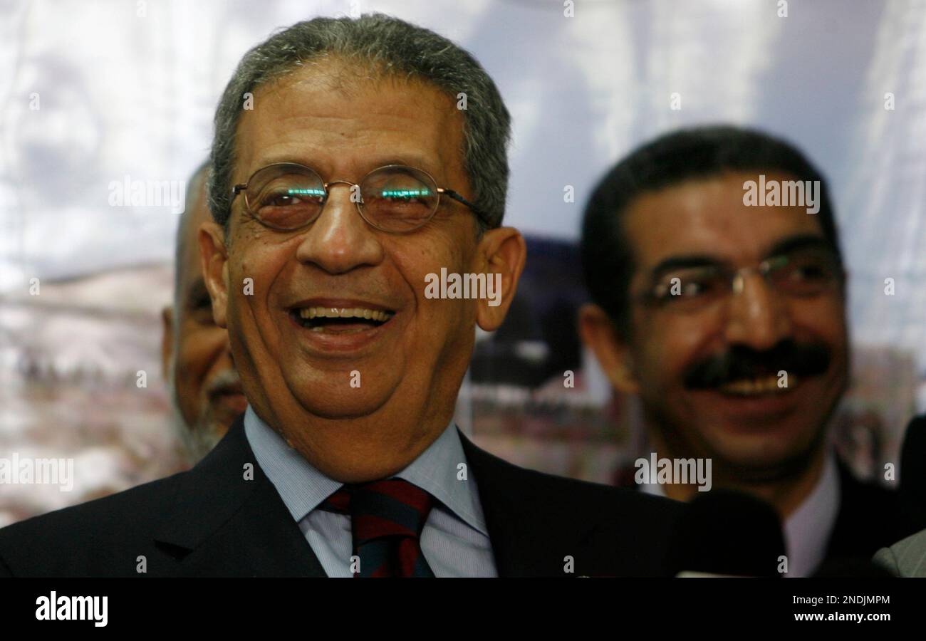 Arab League Secretary General Amr Moussa, center, laughs while talking ...