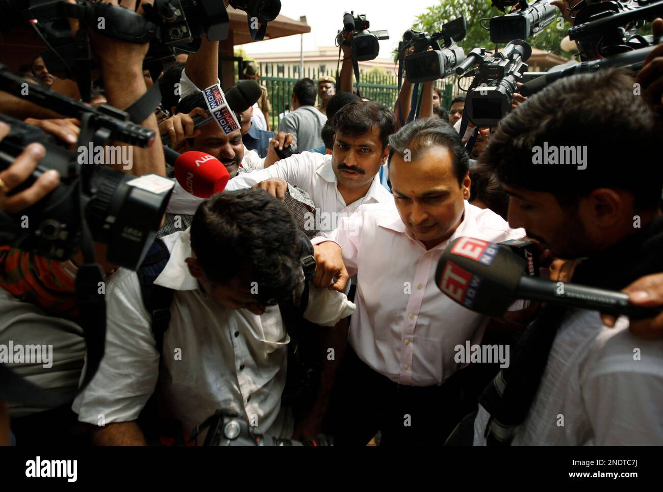 Indian billionaire Anil Ambani, center right in pink shirt, comes out ...