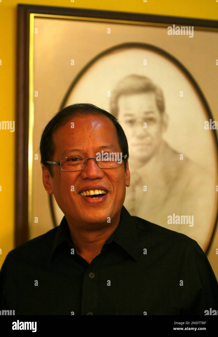 Presidential candidate Sen. Benigno "Noynoy" Aquino III poses next to a ...