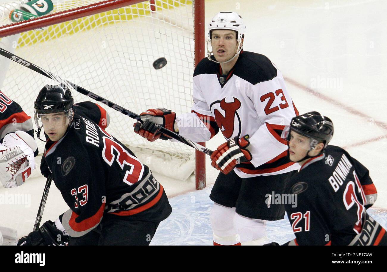 Carolina Hurricanes' Bryan Rodney (33) and Drayson Bowman (21) keep an ...