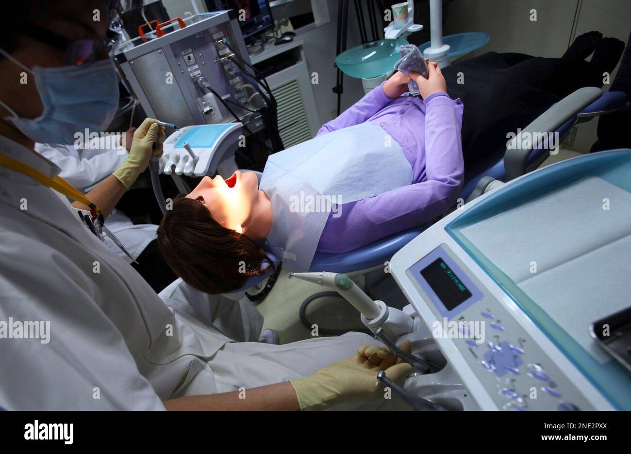 A dentist demonstrates a training procedure, using the new humanoid ...