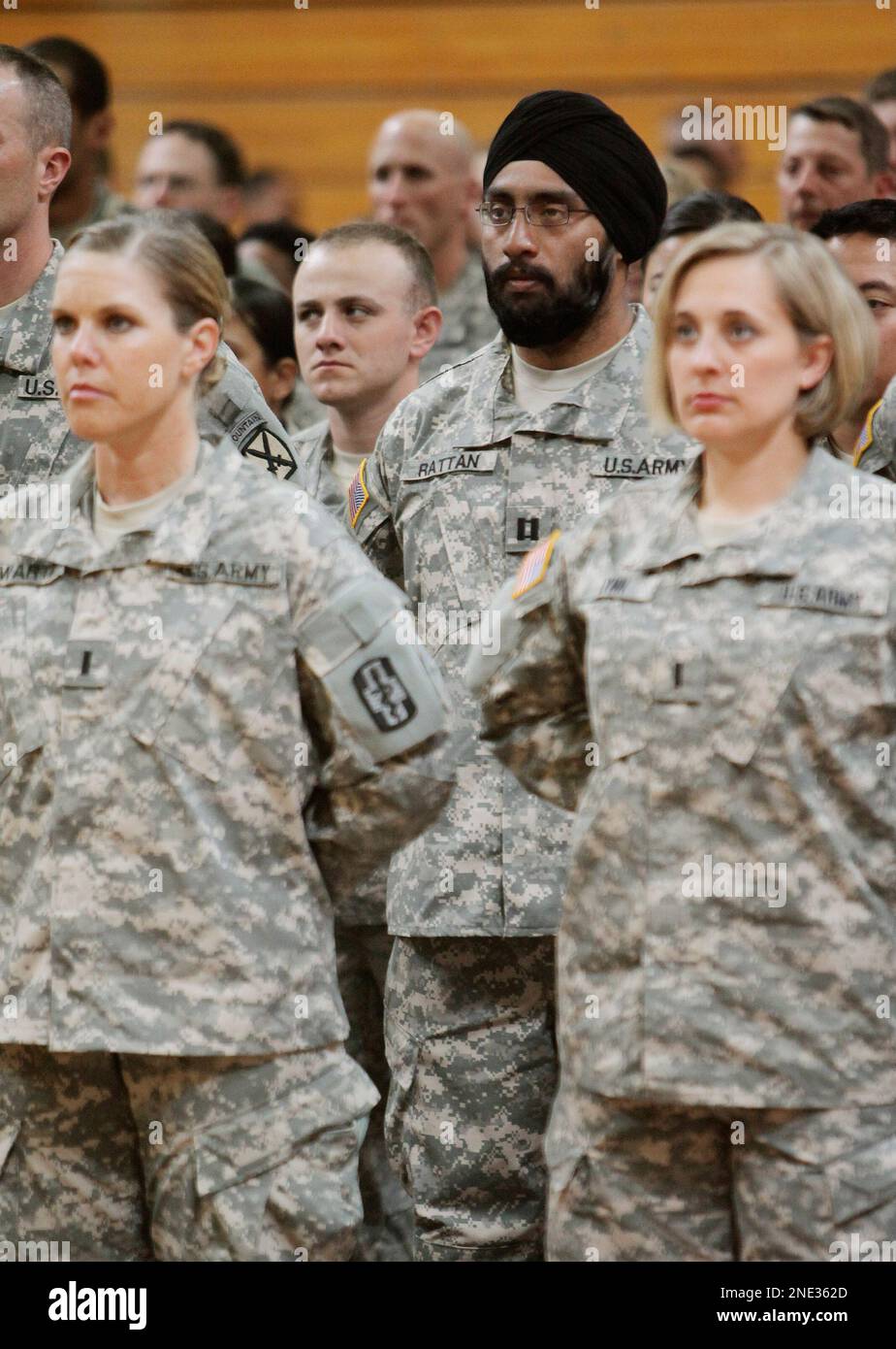U.S. Army Capt. Tejdeep Singh Rattan, center wearing turban, stands ...