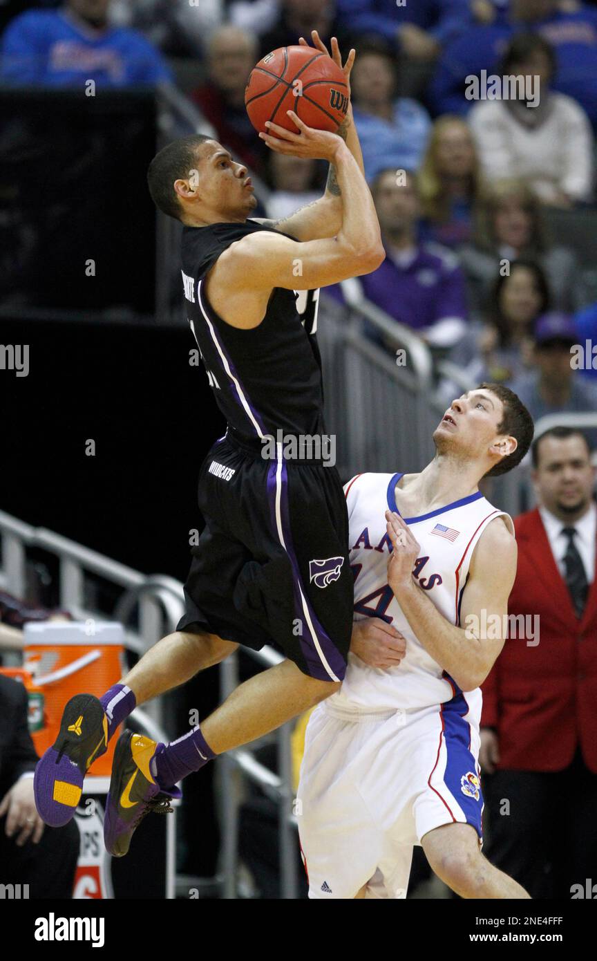 Kansas State guard Denis Clemente, left, shoots over Kansas guard Tyrel ...