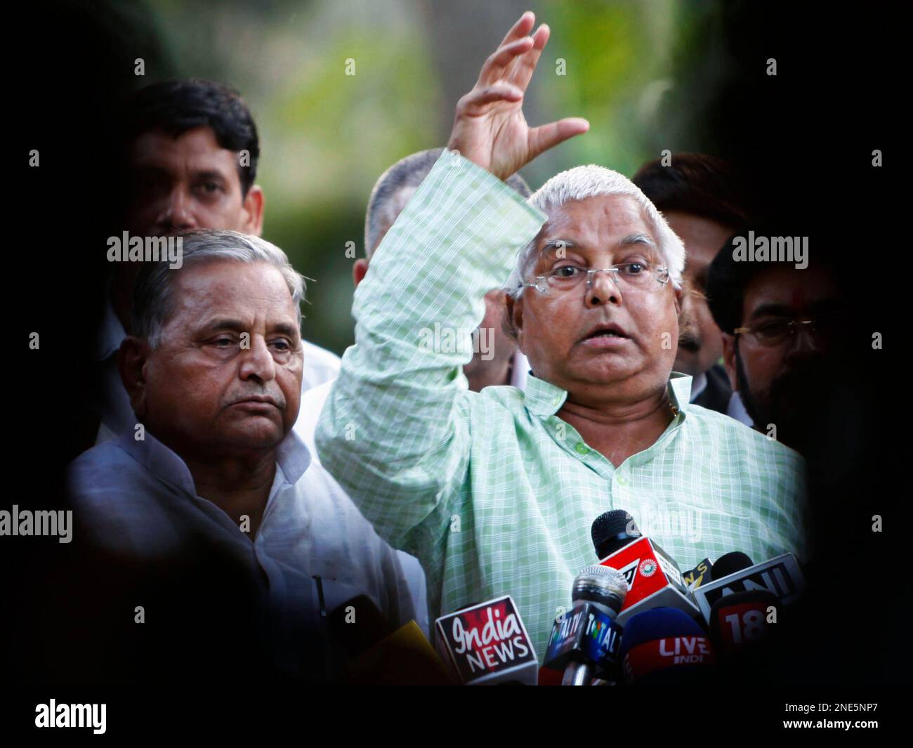 Samajwadi Party leader Mulayam Singh Yadav, left, looks on as Rashtriya ...
