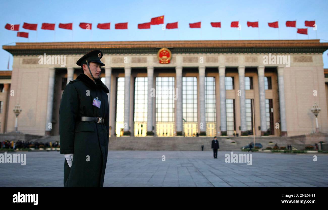 A paramilitary police officer stands guard in front of the Great Hall ...