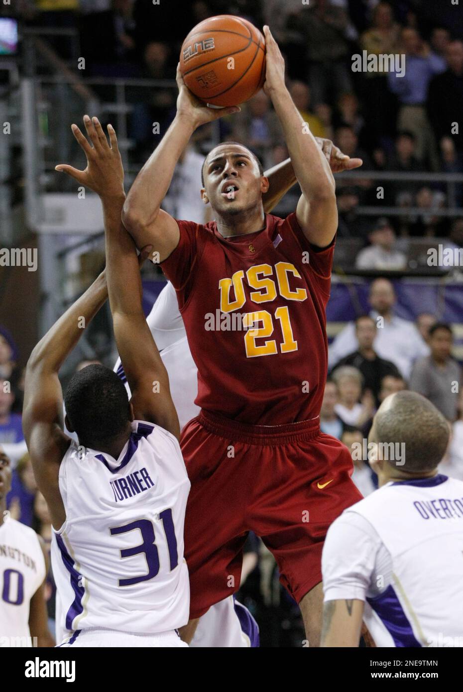 Southern California's Dwight Lewis shoots between Washington's Elston ...