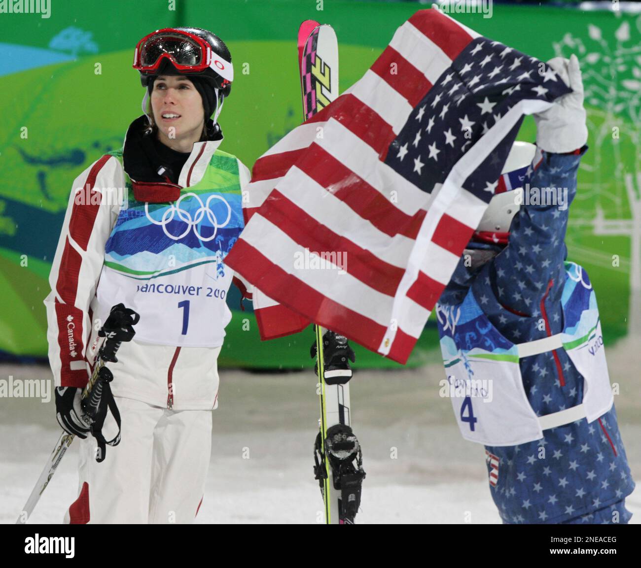 Canada's Jennifer Heil, left, of Spruce Grove, Alta., looks on as ...