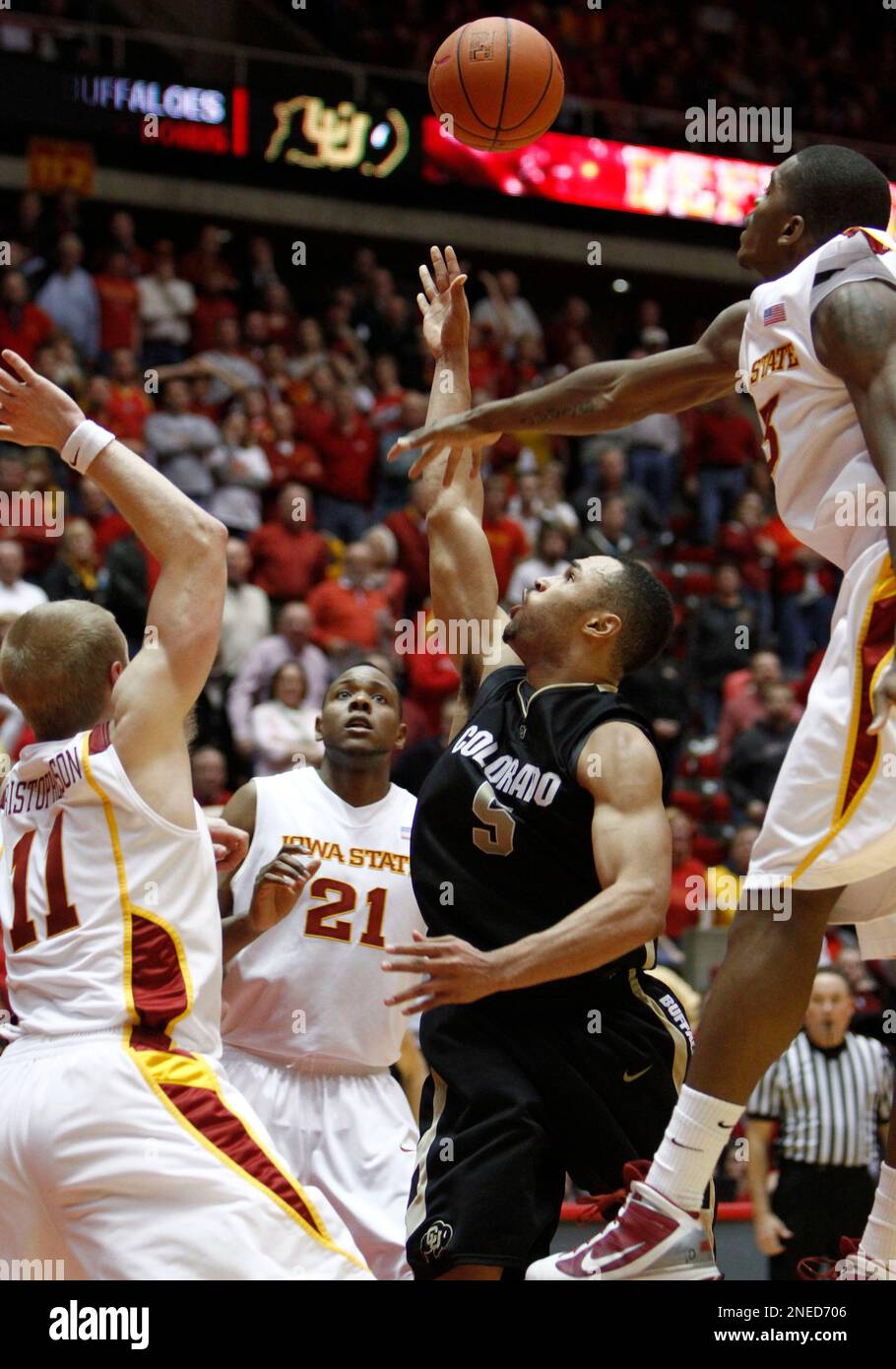 Colorado's Marcus Relphorde, center, drives to the basket between Iowa ...