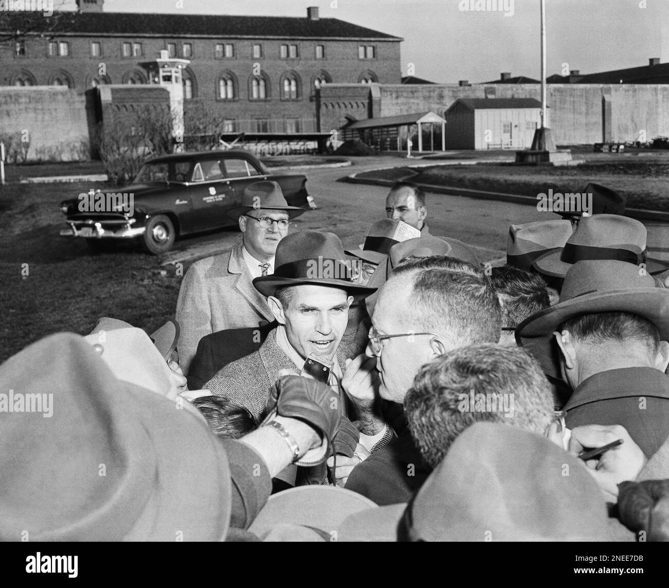 Alger Hiss, Former State Department official, is interviewed by newsmen ...