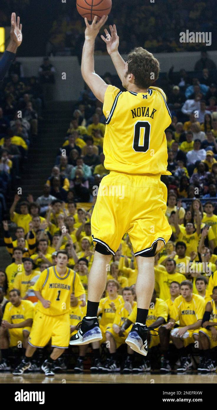 Michigan guard Zack Novak shoots a 3-point basket late in the second ...