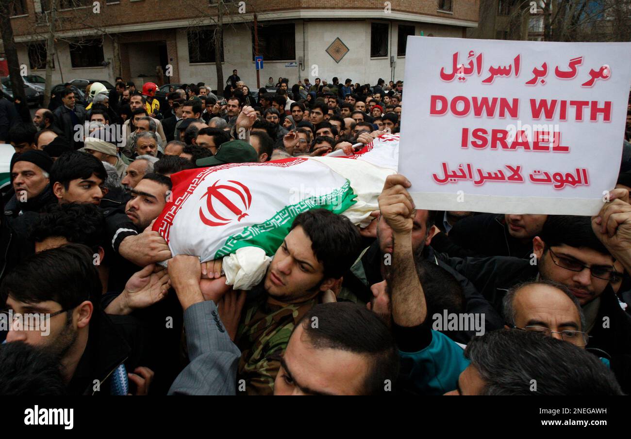 People carry the flag-draped body of slain Iranian physics professor ...