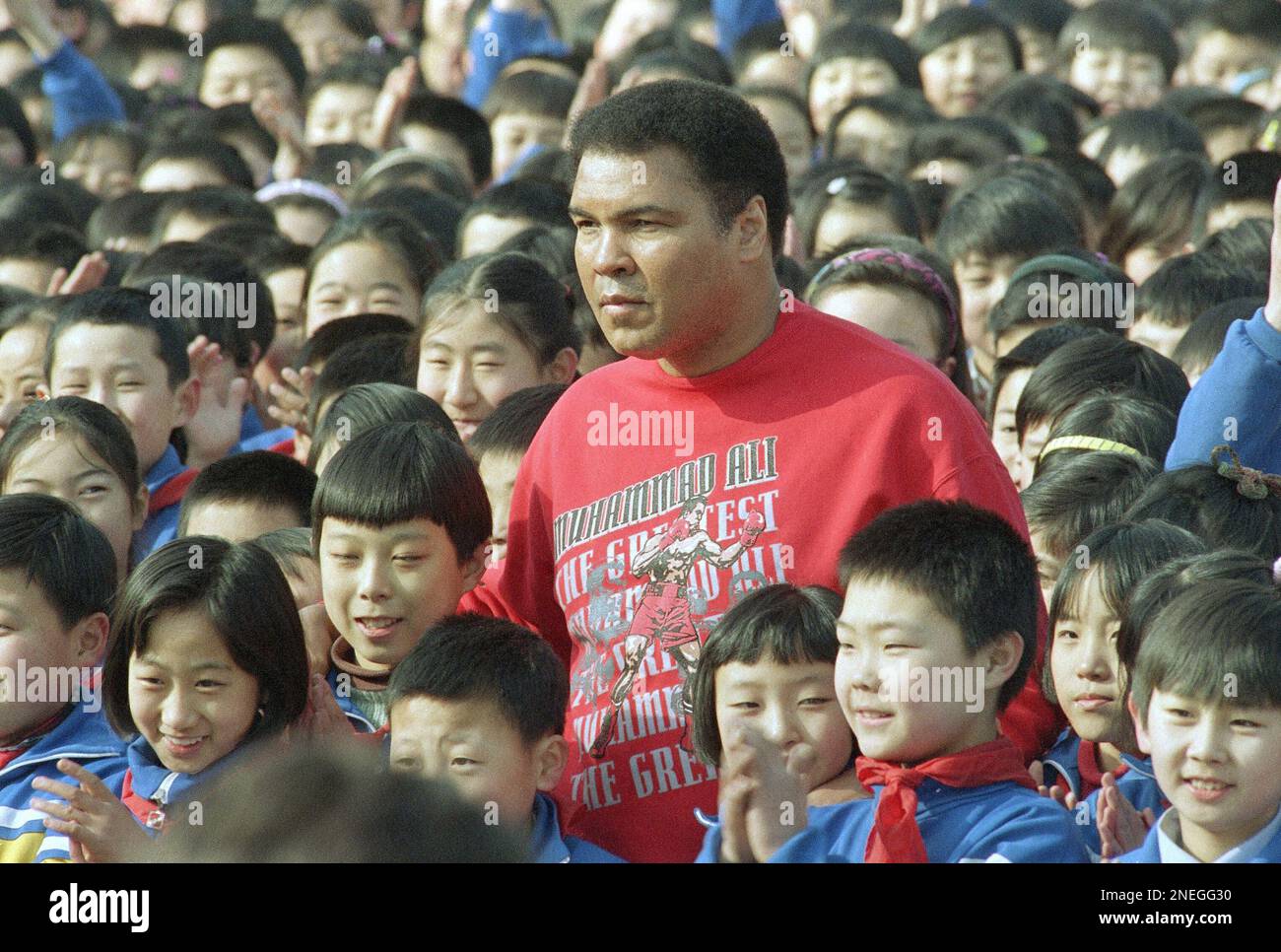Former world heavyweight boxing champion Muhammad Ali is surrounded by ...