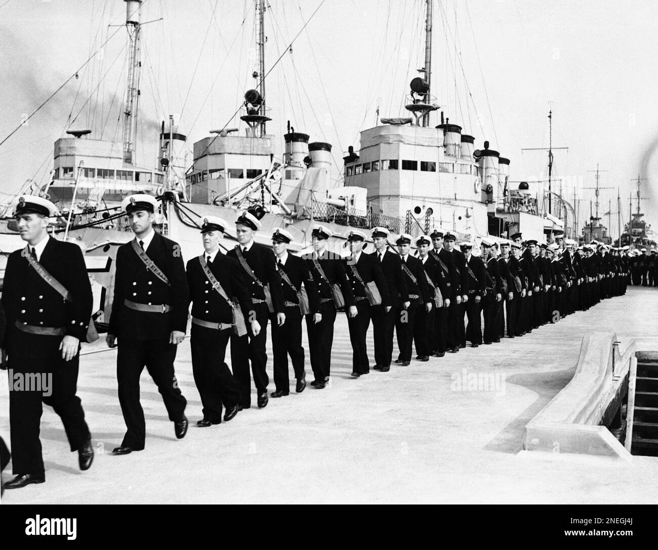 Officers and men of the Canadian Navy marching in single line along the ...