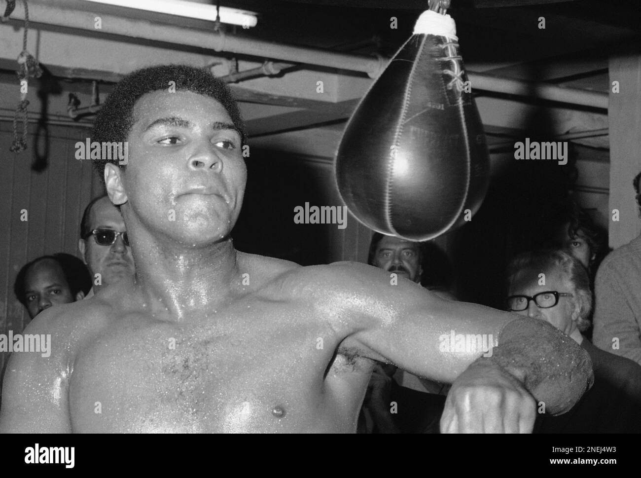 World heavyweight champion Muhammad Ali, lips pursed and beads of sweat ...