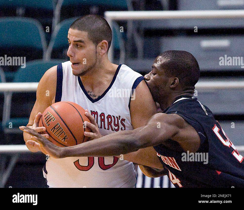 Saint Mary's center Omar Samhan (50) battles Northeastern center Nkem ...