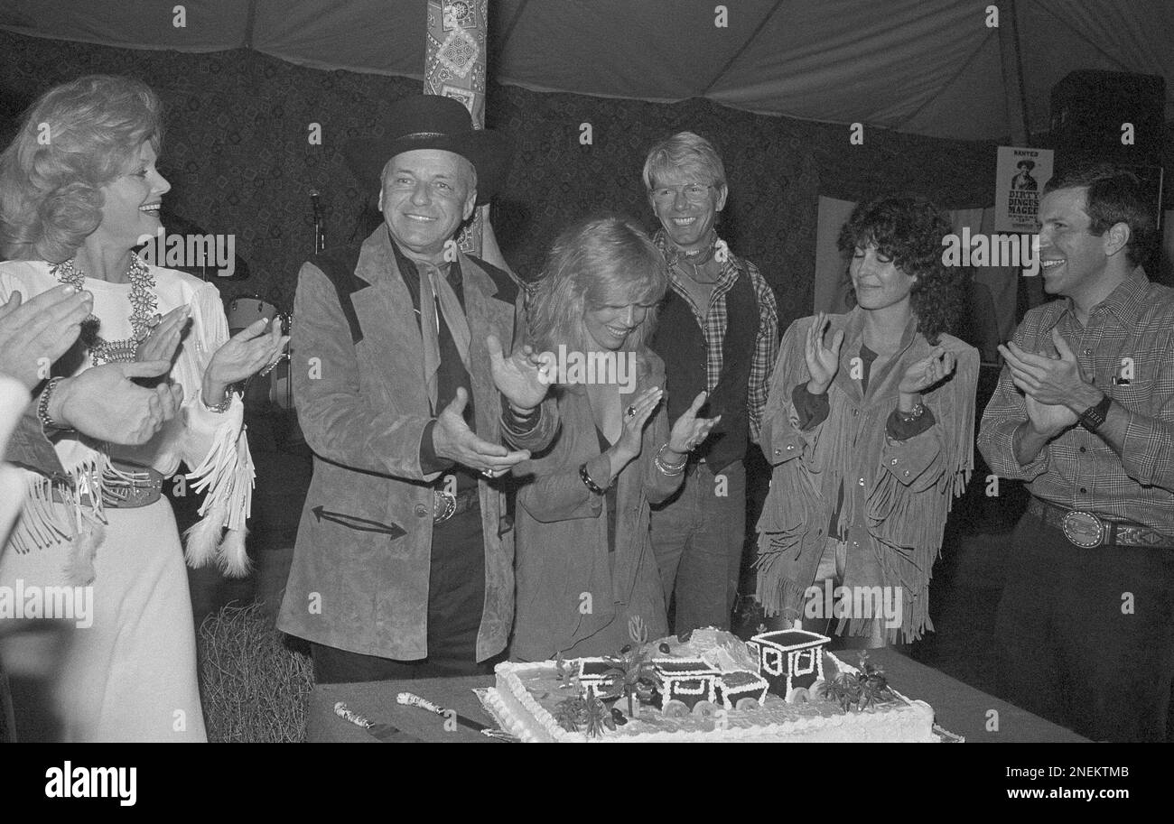 Entertainer Frank Sinatra, second from left, joins in the applause as ...