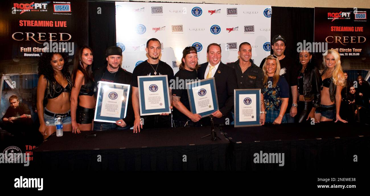 Center - Creed bassist Brian Marshall, guitarist Mark Tremonti, drummer ...