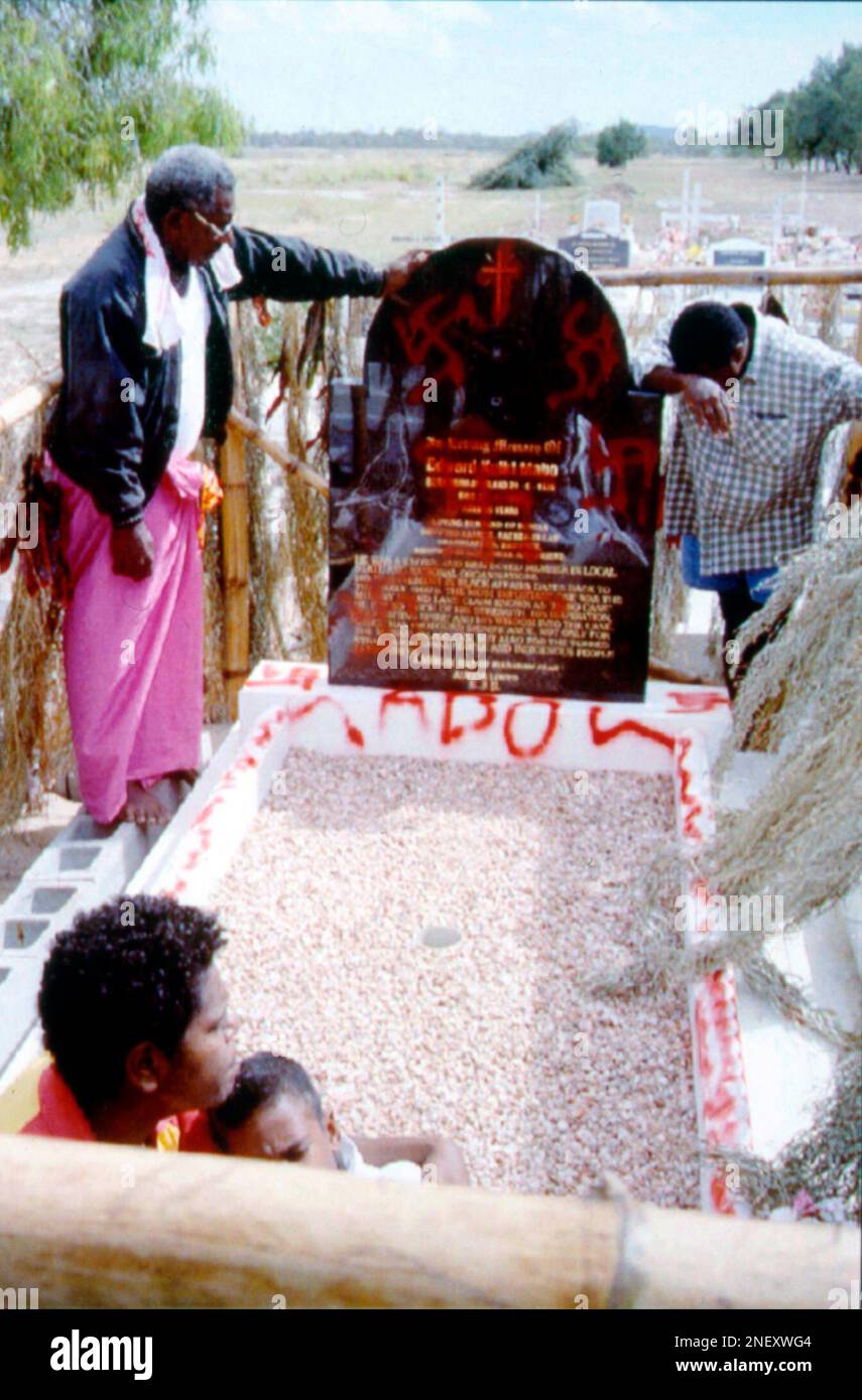 Members of the Torres Strait Island community weep over the desecrated ...