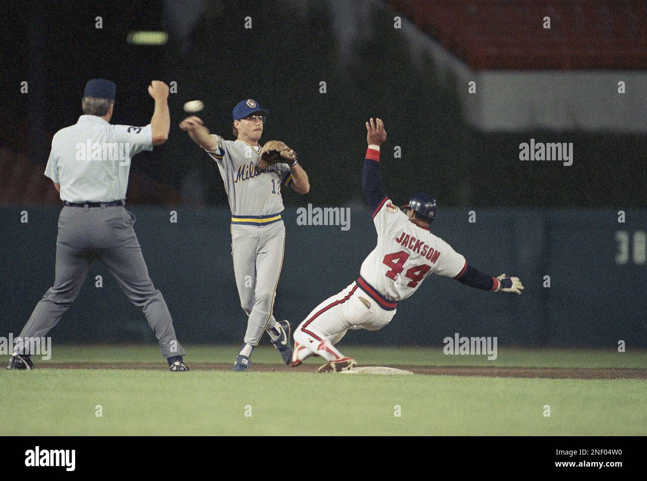 Milwaukee Brewers second baseman Jim Gantner twists around as he throws ...